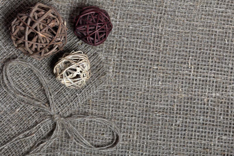 Coarse Linen Fabric. on it are Rattan Balls and a Bow of Linen Threads ...