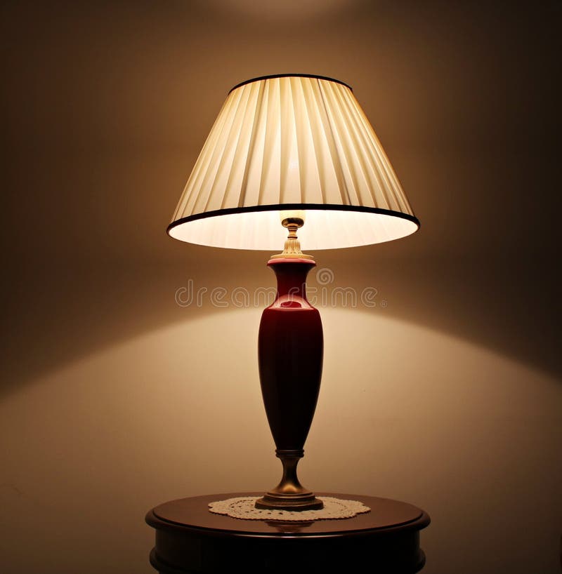 Coassic Elegant Lamp with Illuminated Lampshade on a Small Round Table ...