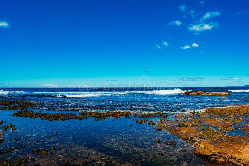 The Blue Sea Merging with the Sky Stock Photo - Image of umbrellas ...