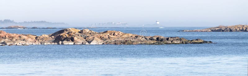 Coast, Cliffs and a Distant Beacon Surrounded with Fog Sunny Day Stock ...