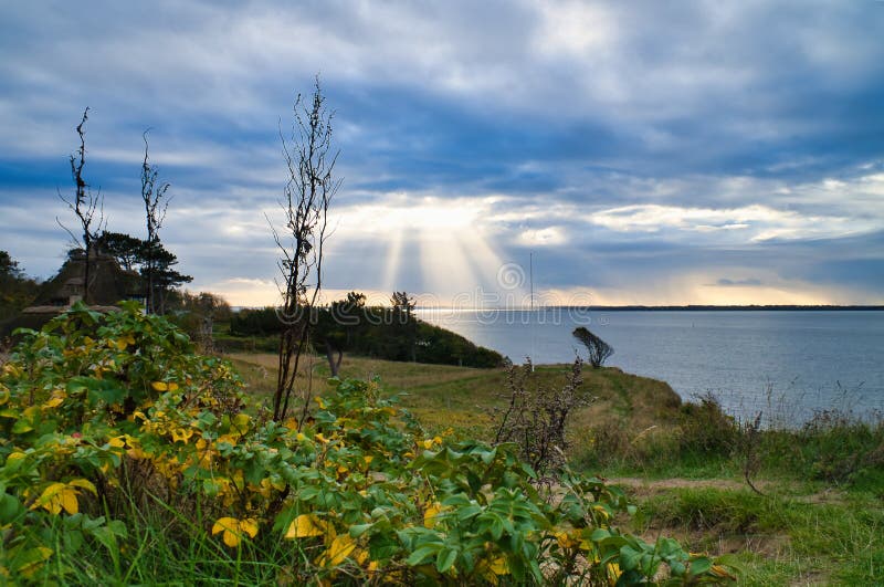 On the Coast of Hundested. Sun Rays Break through the Dramatic Sky ...