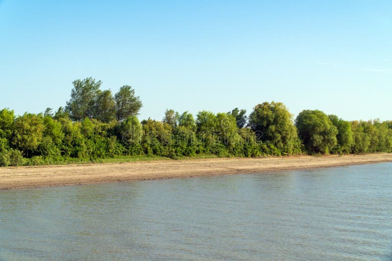 Coast of a wide flat river stock photo. Image of beauty - 151001876