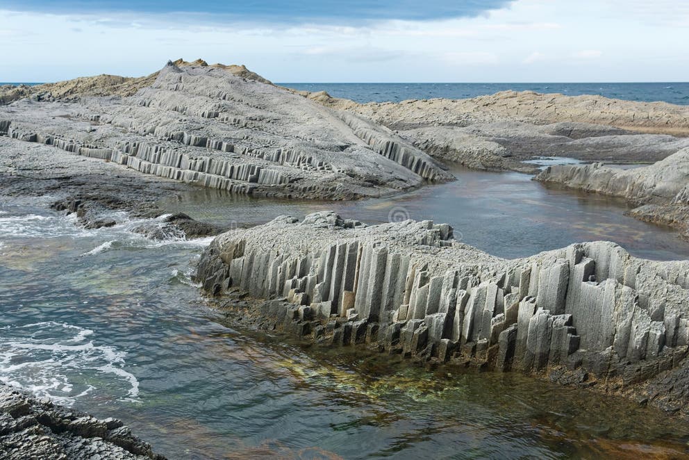 Coastal Cliffs Formed by Columnar Basalt at Low Tide Stock Image ...
