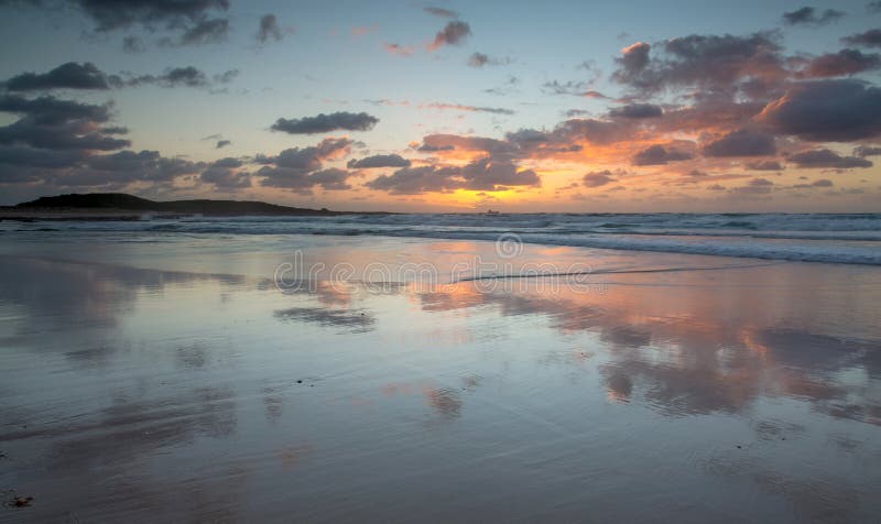 Mirrored Coastal Reflections in Wet Beach Sand at Sunrise Stock Photo ...