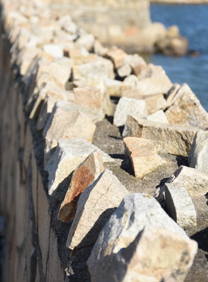 Coastal Retaining Wall with Sharp Jagged Rocks Stock Photo - Image of ...