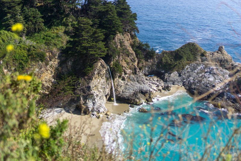 Coastal Waterfall Cascading Onto Pacific White Sand Beach Surrounded by ...
