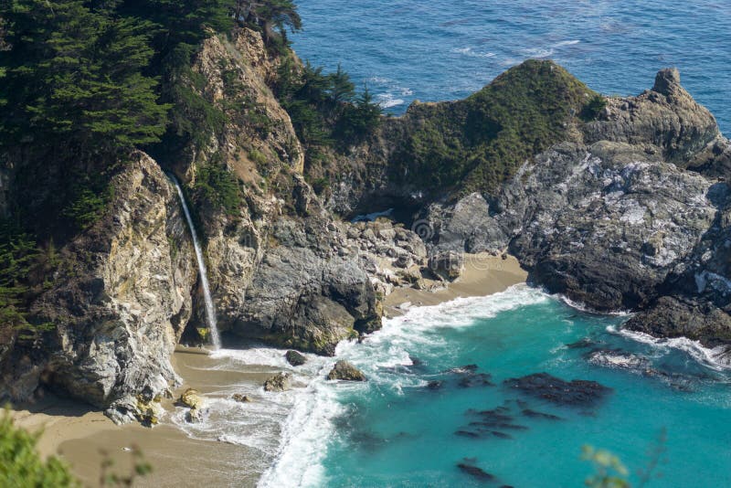 Coastal Waterfall Cascading Onto Pacific White Sand Beach Surrounded by ...