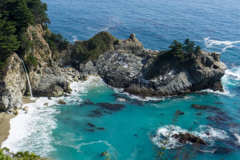 Coastal Waterfall Cascading Onto Pacific White Sand Beach Surrounded by ...