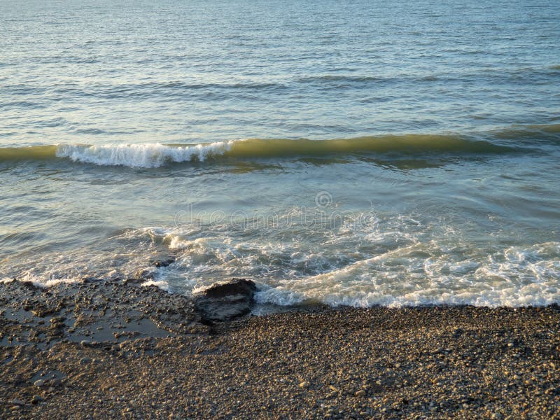 Coastline. Waves Gently Roll on the Shore. Pebble and Black Sand Beach ...