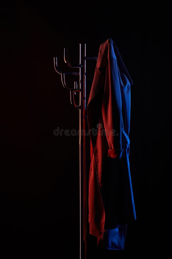 Hat and Coat Hanging on Coat Rack on Black Stock Photo - Image of ...