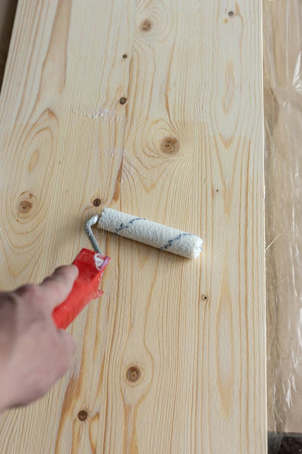 Coating the Board with Varnish Using a Roller Stock Photo - Image of ...