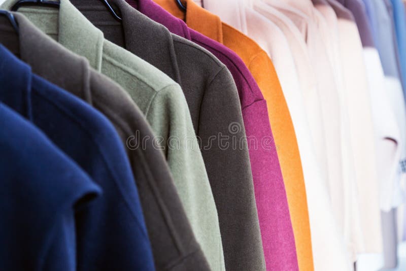 Coats of Different Colors Hang on a Hanger Stock Image - Image of ...