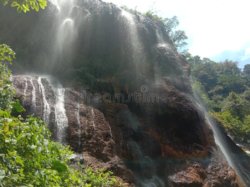 Coban Pelangi Waterfall stock image. Image of river - 210479809