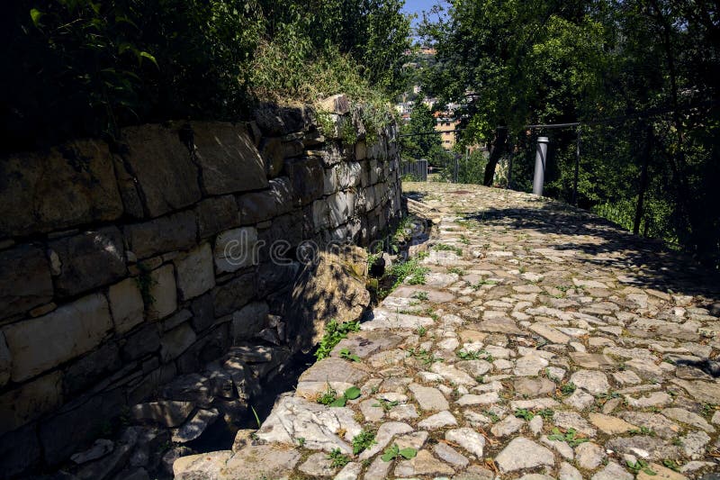 Cobbled Path by the Edge of a Cliff with Trees on a Clear Sunny Day ...