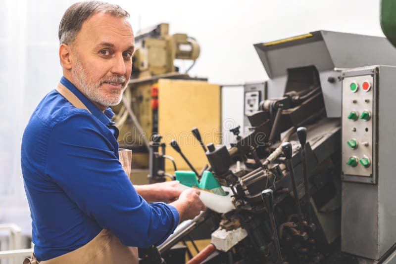 Cobbler Stitching Boots and Looking at Camera Stock Photo - Image of ...