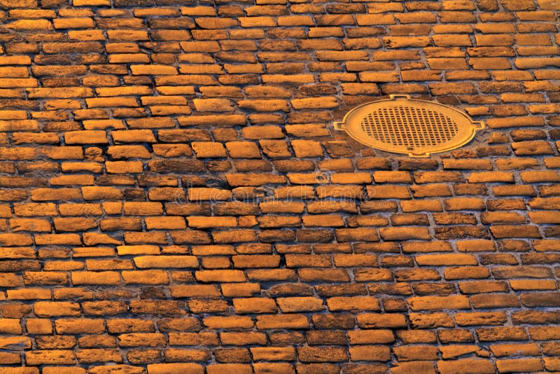 Cobblestone and Sewage Hatch in Golden Rays Stock Image - Image of ...