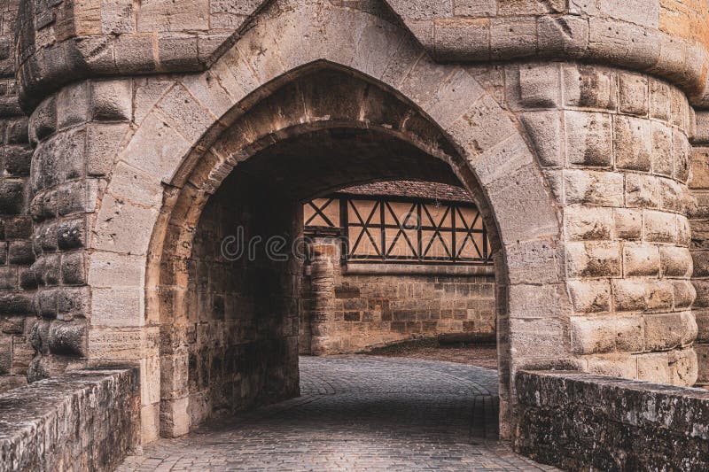 Cobblestone Street with a Stone Arch in a Medieval Building Stock Image ...