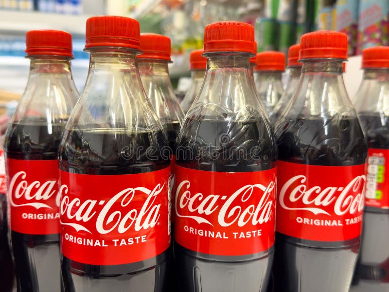 Coca-cola Bottles on Store Shelf with Red Caps and Labels Editorial ...