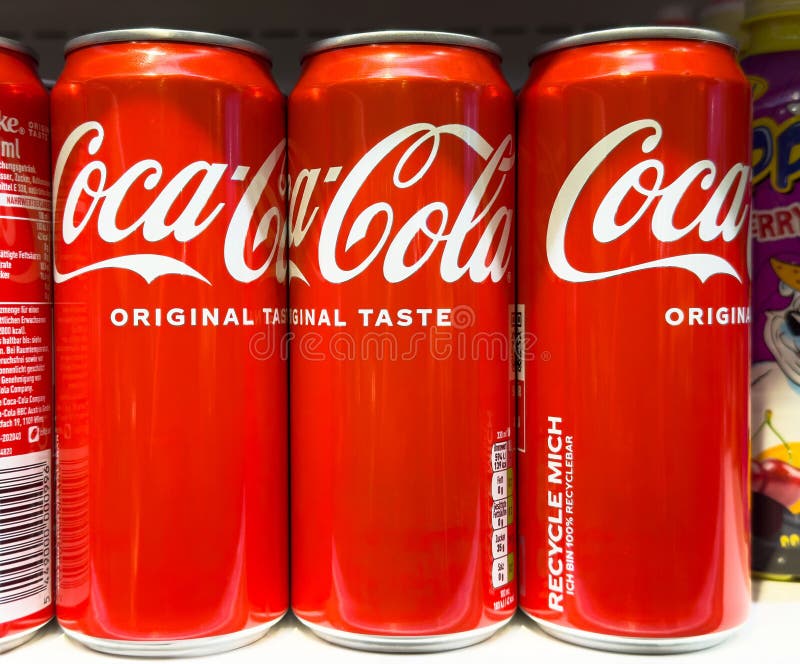 Coca-cola Cans Displayed on Store Shelf with Vibrant Red Packaging and ...