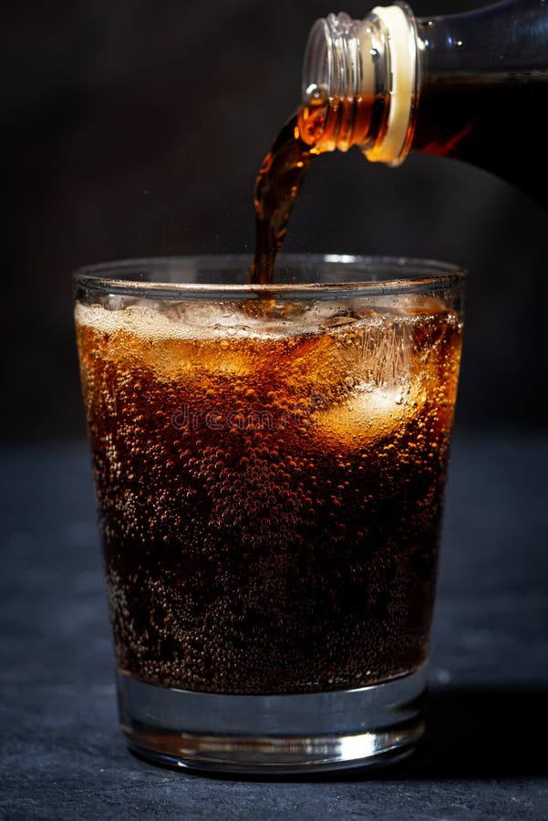 Coca Cola is Pouring into a Glass from a Bottle, Closeup Vertical Stock ...