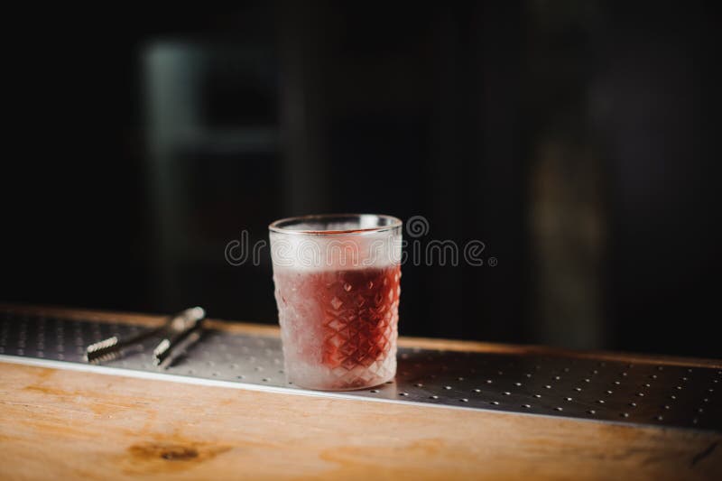 Cocktail on a Dark Bar Setting Stock Image - Image of black, dessert ...