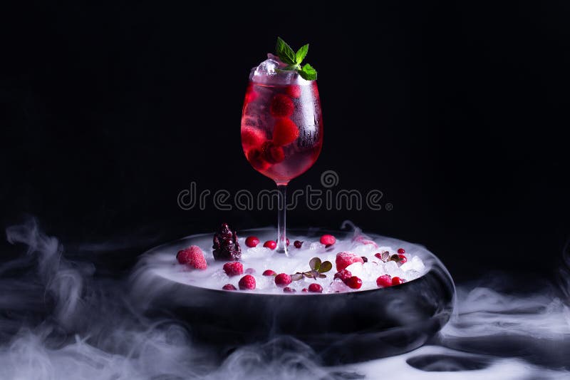 Cocktail with Fresh Berries with Ice and Steam Stock Photo - Image of ...