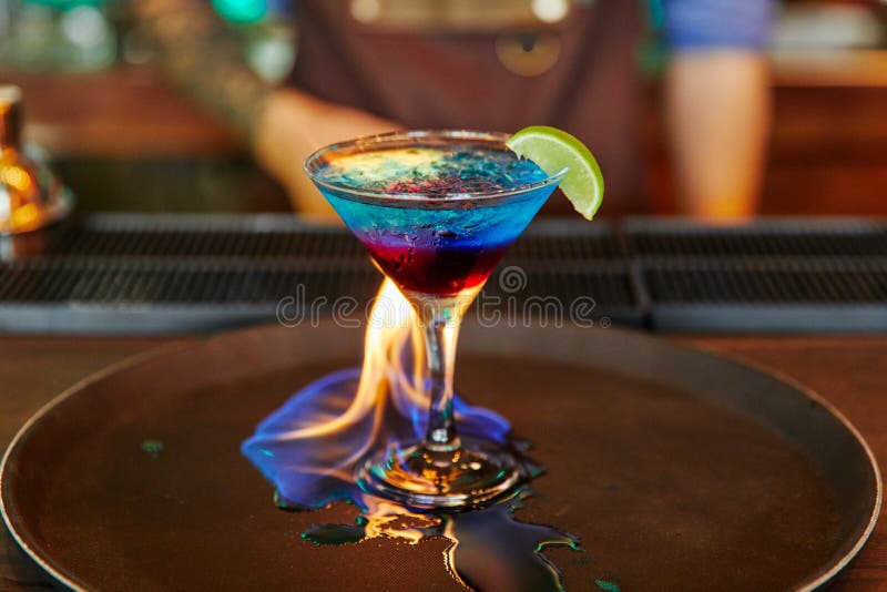 Cocktail with Lime Burning Fire in a Glass Goblet, Alcohol Stock Image ...