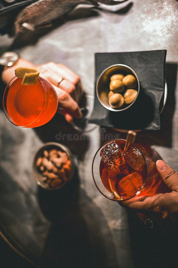 Cocktail Negro I and a Mezcal in a Table with Olives and Almonds Stock ...