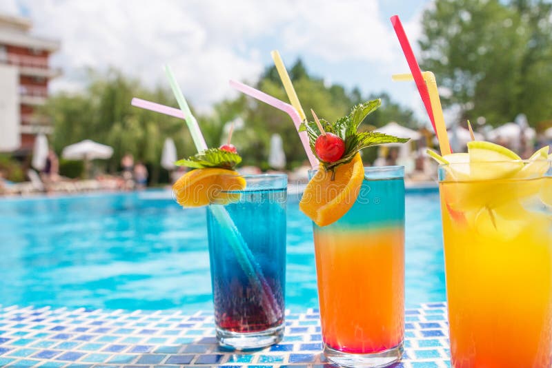 Cocktails by the pool stock image. Image of holiday - 168407897