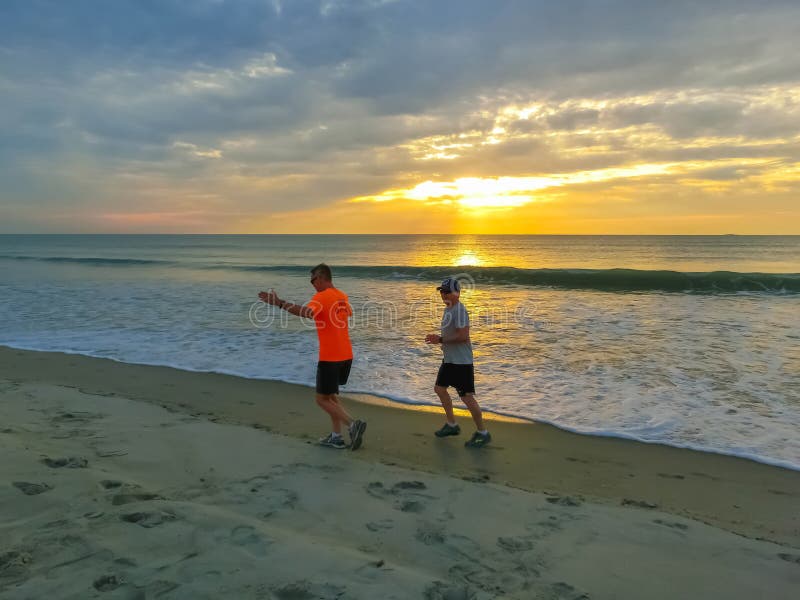Cocoa Beach, Florida, USA - April 29, 2018: Men Running on the Beach at ...