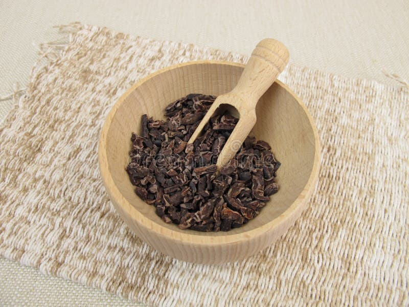 Cocoa nibs in wooden bowl stock photo. Image of chocolate - 71608162