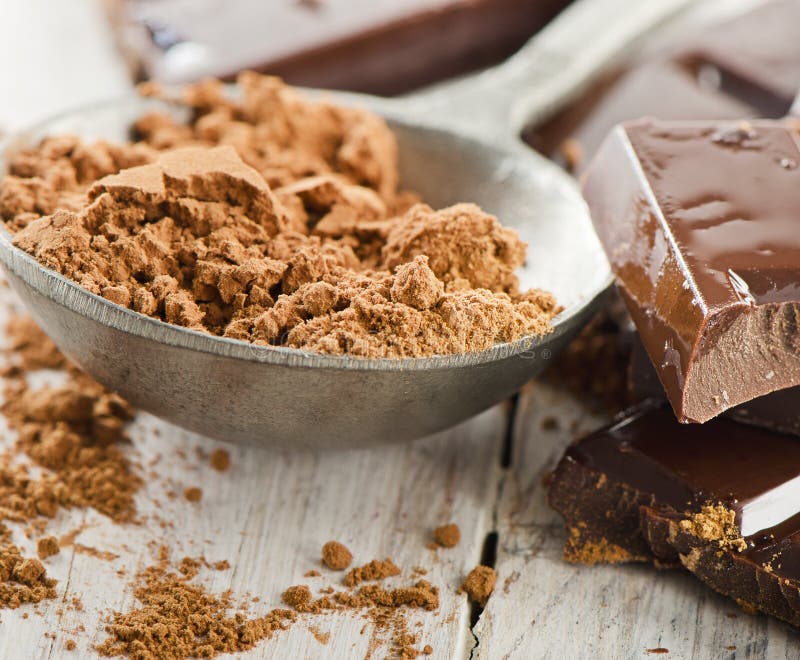 Cocoa Powder and Broken Chocolate Bar and on a Wooden Table Stock Image ...