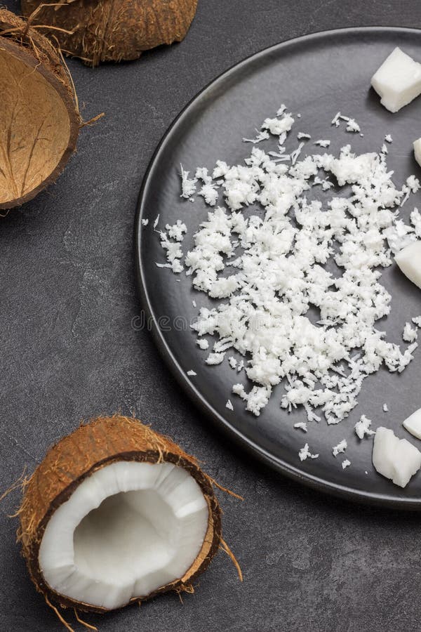 Coconut Flakes on Black Ceramic Plate. Coconut Shells Stock Image ...