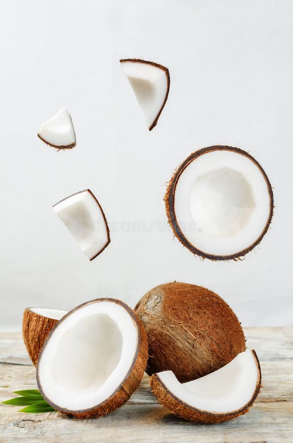 Coconut with flying slices stock image. Image of summer - 121381403