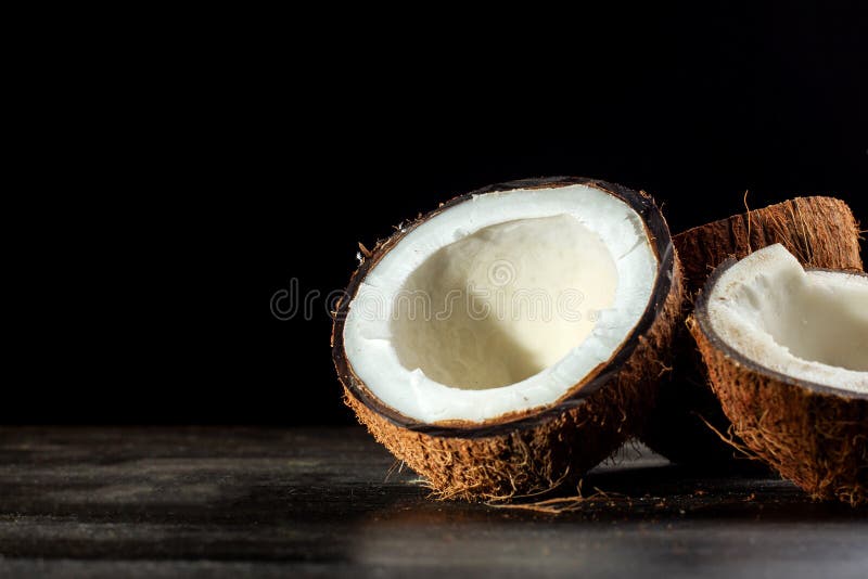 Coconut Halves on a Black Background. Back Light Stock Image - Image of ...