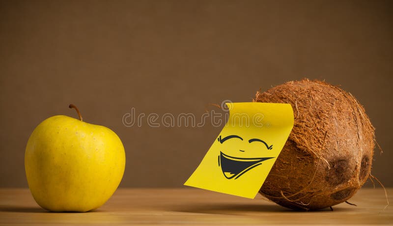 Coconut with Post-it Note Laughing on Apple Stock Photo - Image of ...