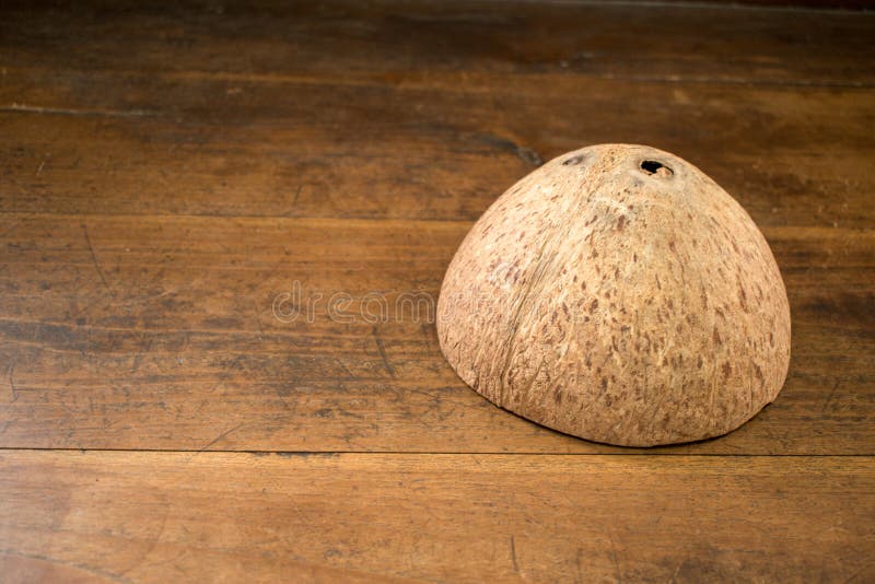 Coconut Shell Upside Down on a Wooden Background Closeup Stock Photo ...