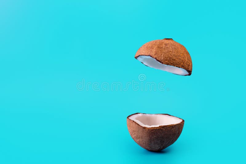 Coconut Split in Half and Flying on Isolated Turquoise Background ...