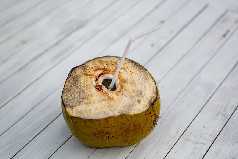 Coconut with a Tube on a White Table Stock Photo - Image of umbrella ...