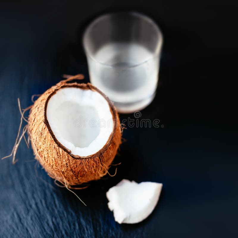 Coconuts with Milk. Coconut with Coconut Milk in a Glass on Dark Stock ...