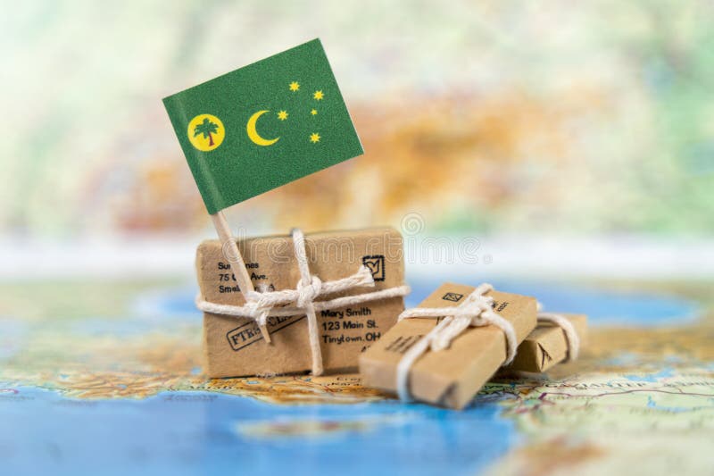 Cocos Islands Flag with Cardboard Parcels on World Map, Symbolizing ...