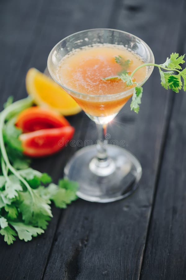 Coctail with Orange and Tomato on Black Wooden Table at Blurred ...