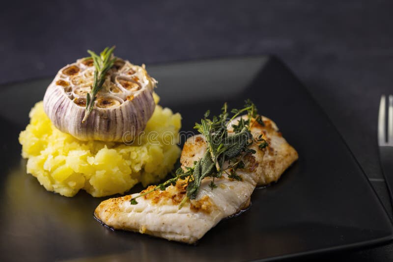 Cod Fillet with Couscous and Roasted Garlic Stock Photo - Image of ...