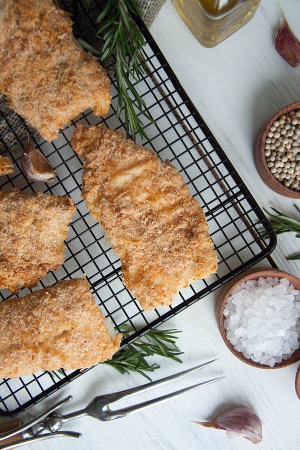 Cod Fish in Breadcrumbs on a Black Wire Rack Stock Photo - Image of ...