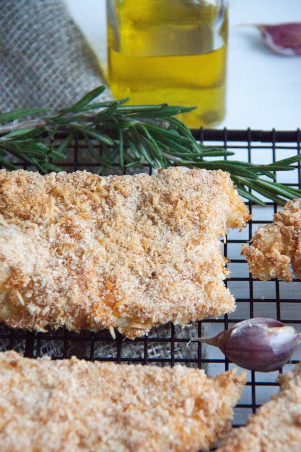 Cod Fish in Breadcrumbs on a Black Wire Rack Stock Photo - Image of ...