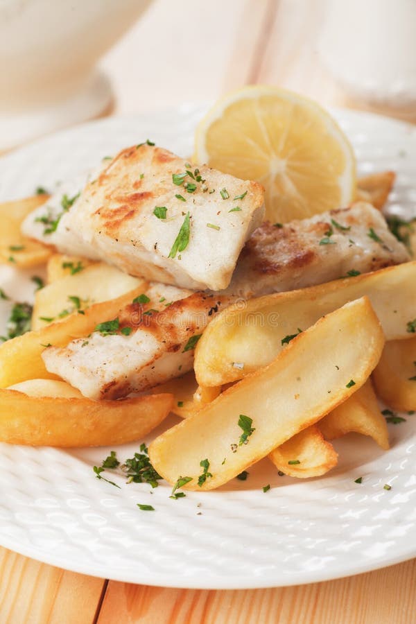 Cod Fish Steak with Fried Potato and Lemon Stock Photo - Image of steak ...