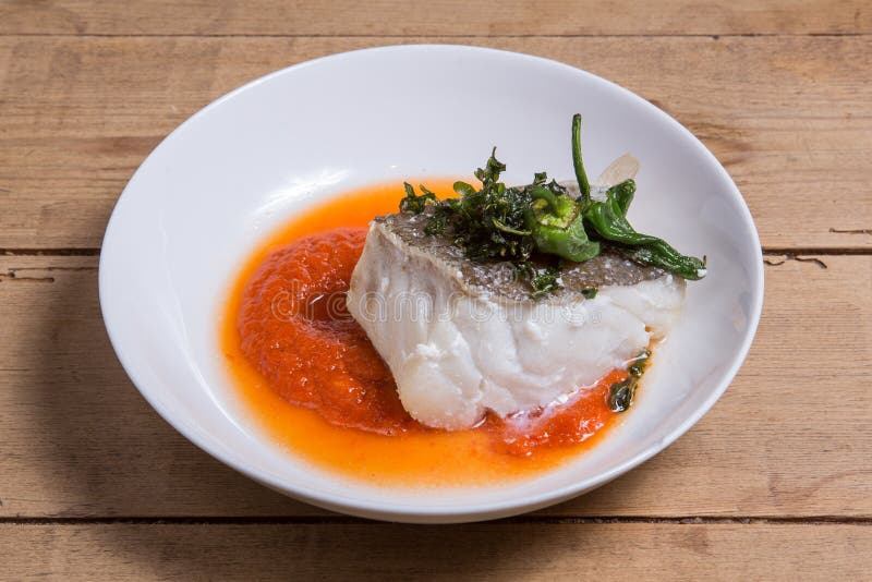Cod fish with tomato cream stock image. Image of style - 268565429