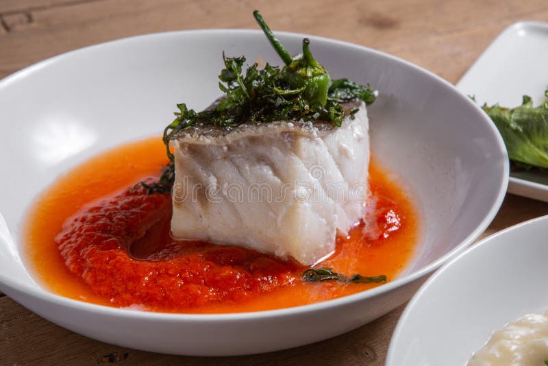 Cod fish with tomato cream stock image. Image of style - 268565471