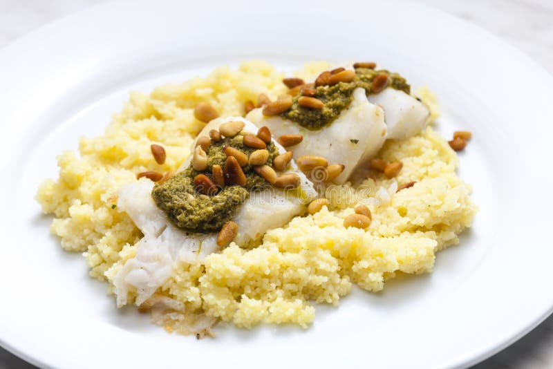 Cod with Green Pesto and Pine Seeds with Couscous Stock Photo - Image ...