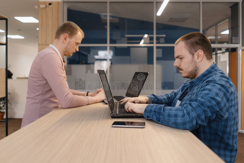 It Coders Working on the Laptop in the Office Standing at the Table ...